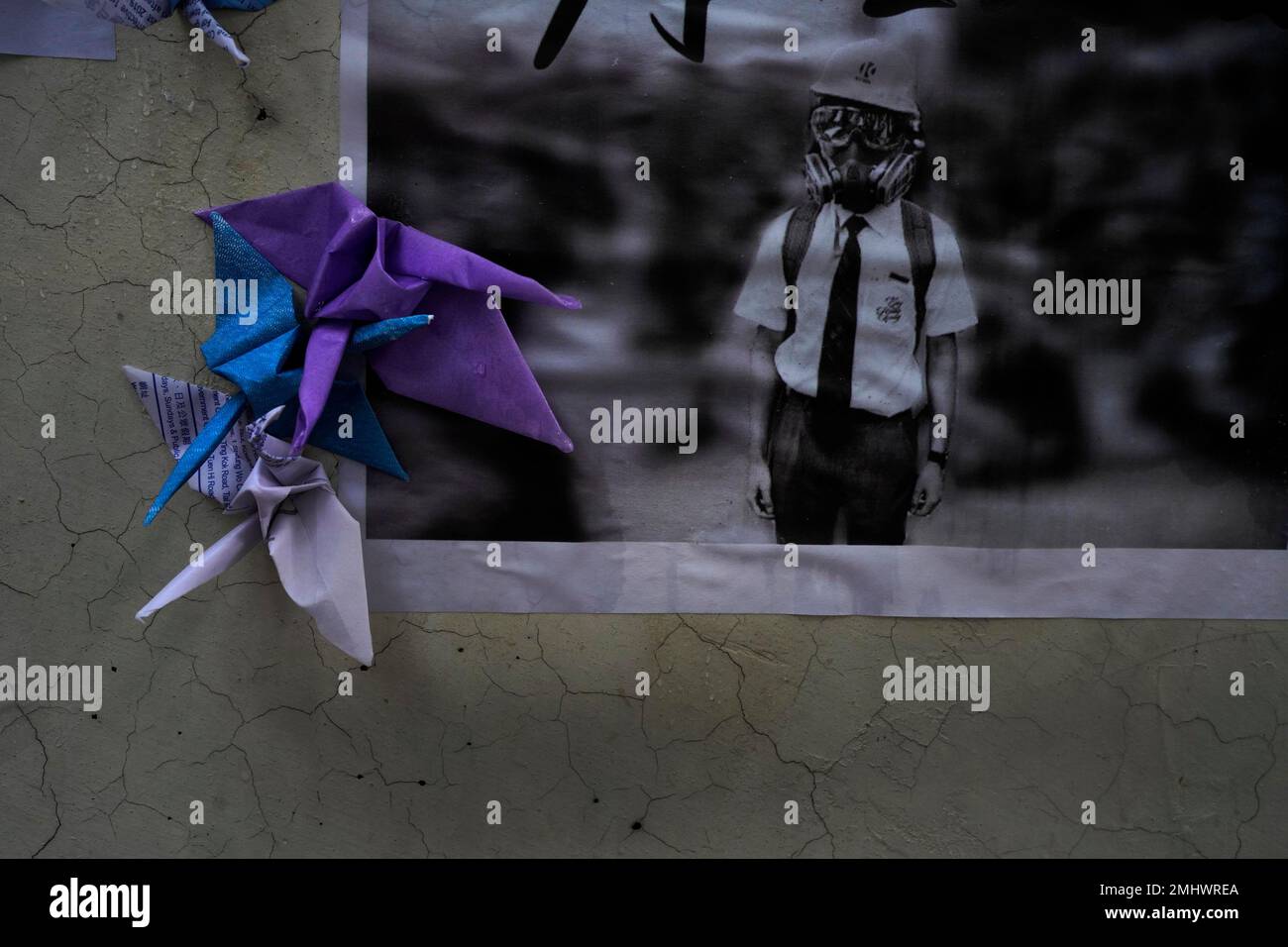 Paper origami cranes are displayed during a sit-in outside police ...
