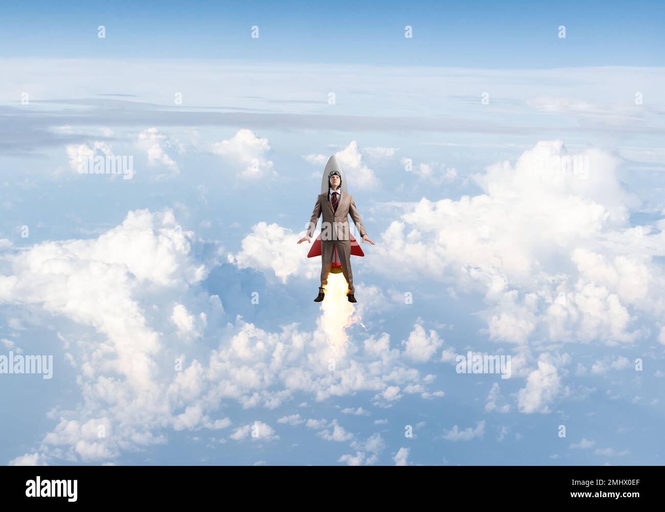 Business person in aviator hat flying on rocket Stock Photo - Alamy