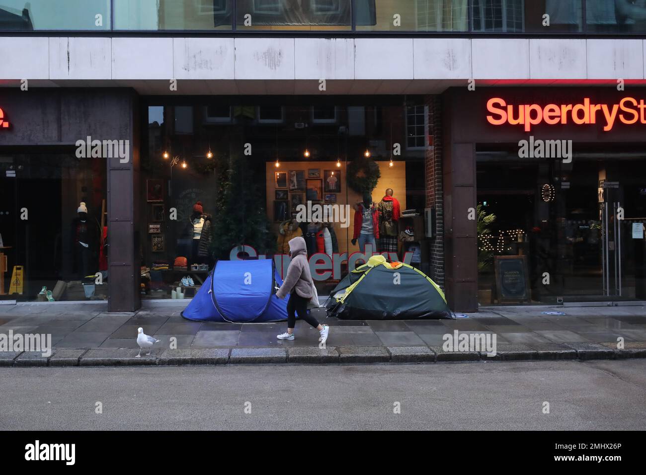 File photo dated 18/01/21 of a woman walks past the tents of homeless ...