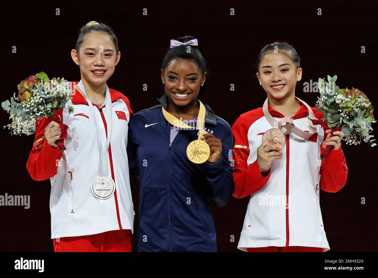 Simone Biles of the United States, center and gold medal, Liu Tingting ...