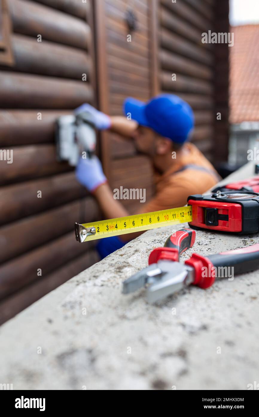 Wooden cottage repair with tools concept Stock Photo - Alamy