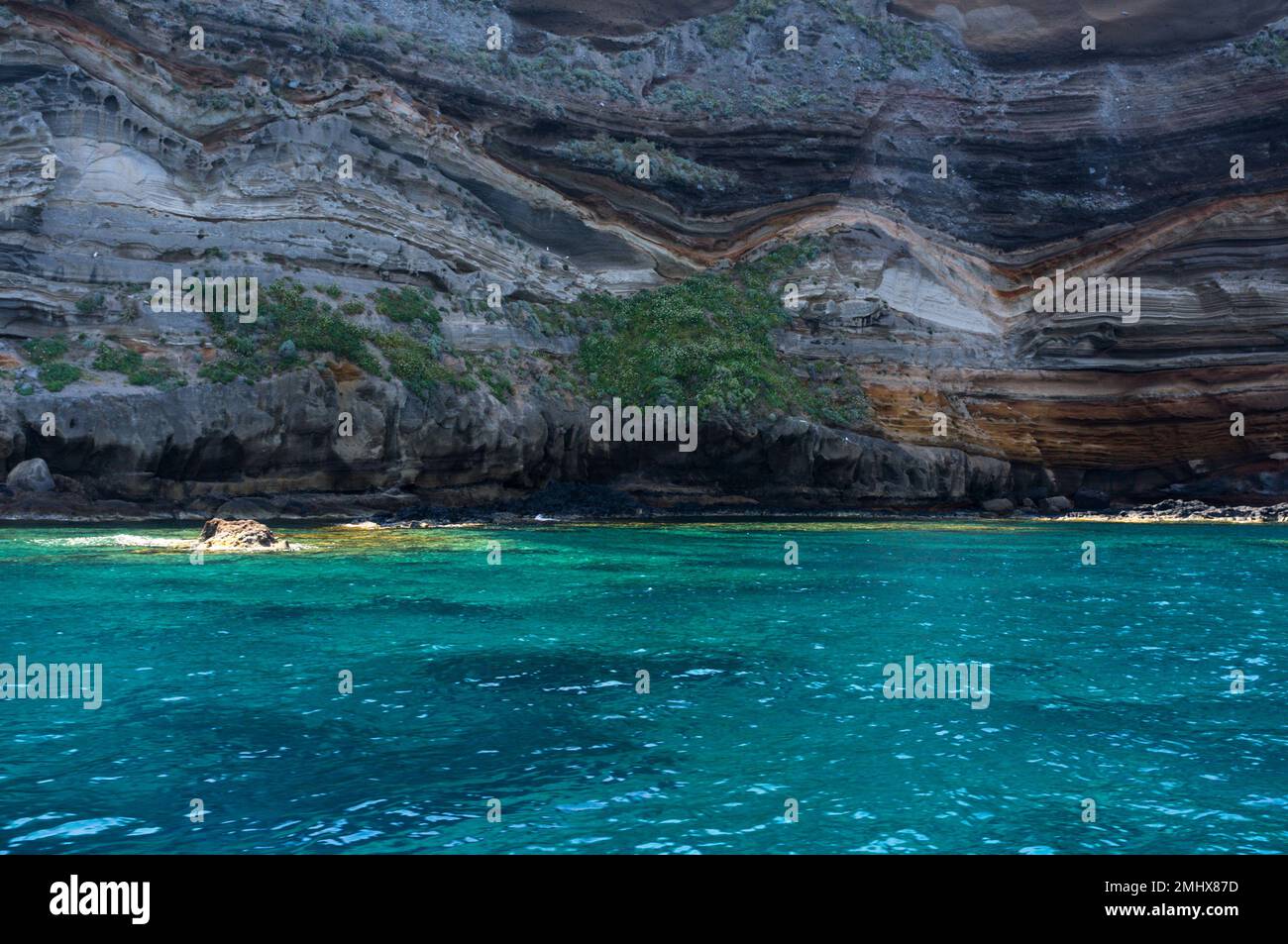 Sea reflection of rock side of Ventotene island Stock Photo - Alamy