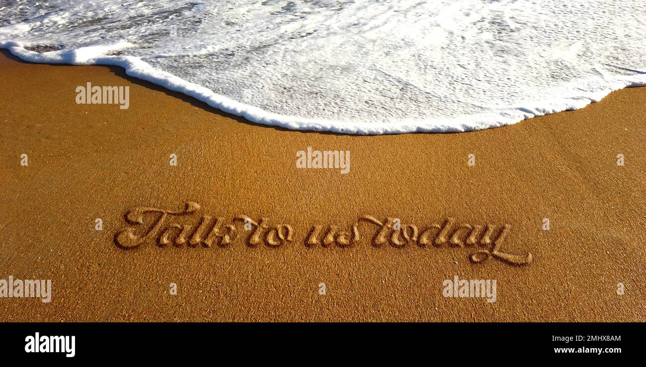 Talk to us today text sign embossed lettering on the sand beach with ...