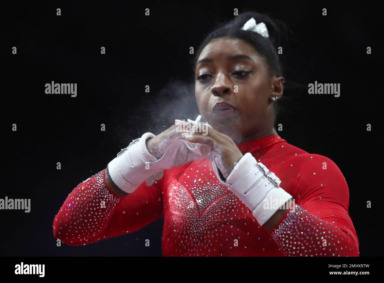 Simone Biles of the United States chalks her hands prior to her ...