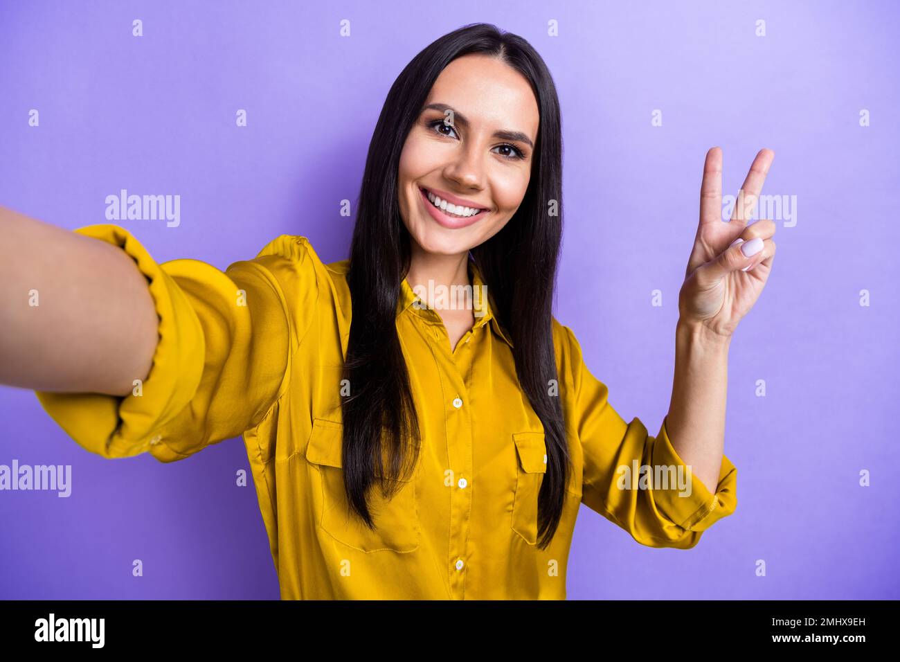 Photo of cheerful adorable lady blogger make selfie hand demonstrate v ...