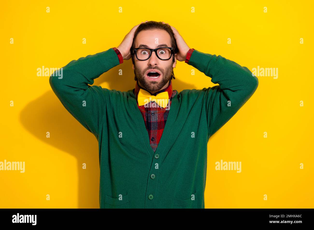 Photo of young stressed scared guy reaction touch hands head open mouth ...