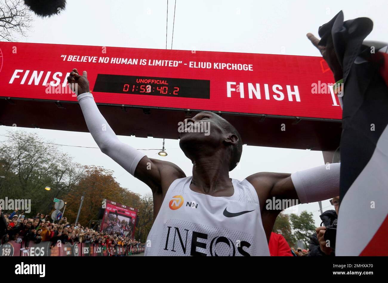 Marathon runner Eliud Kipchoge from Kenya looks to the clock after ...