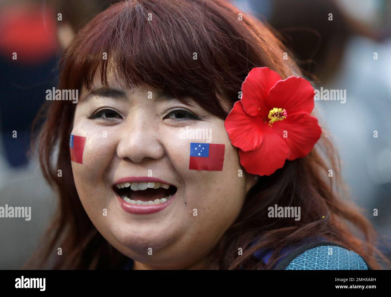A Samoan fan reacts as she arrives at the stadium ahead of the Rugby ...