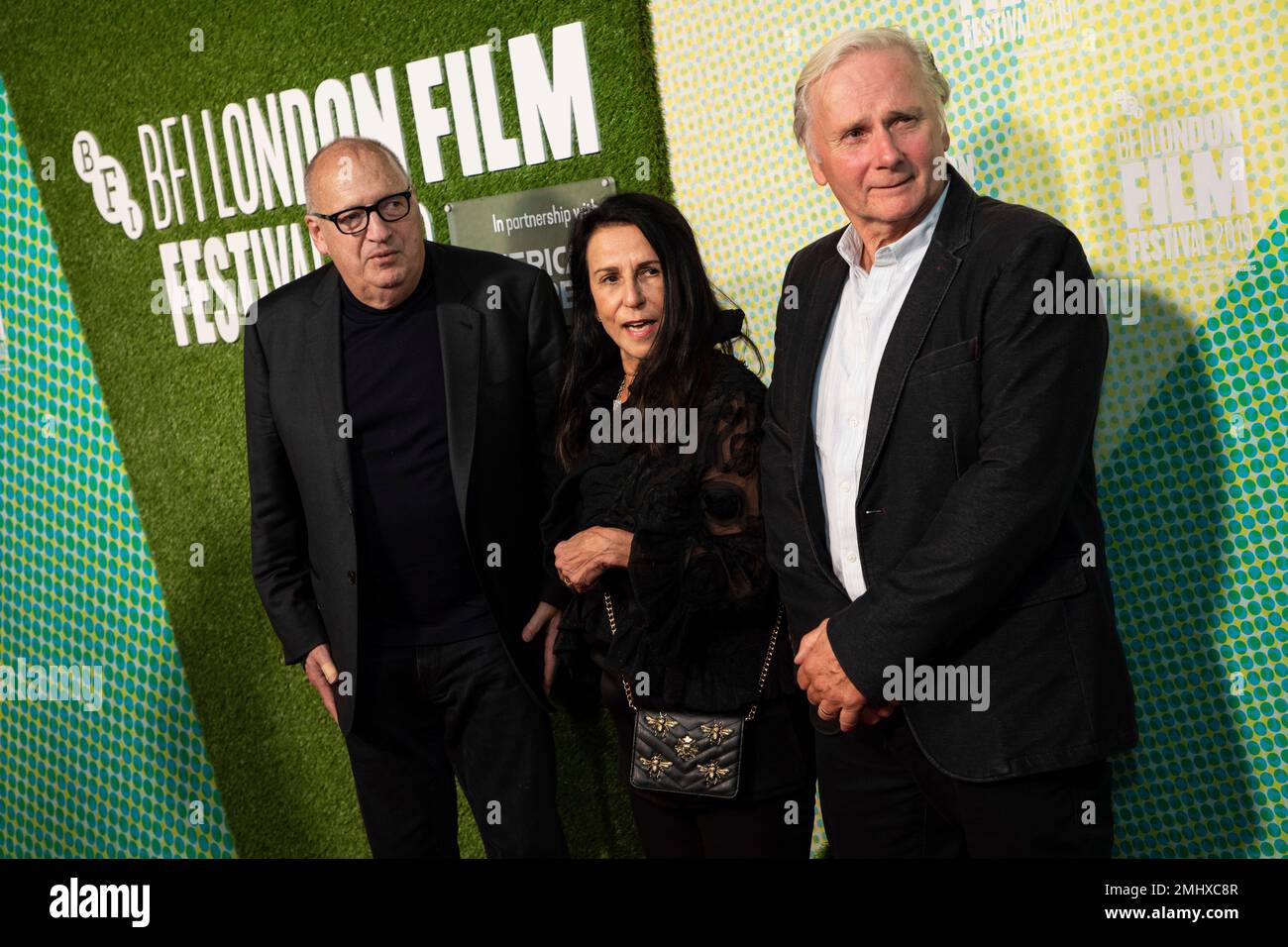 Jon Landau, Barbara Carr and George Travis pose for photographers upon ...