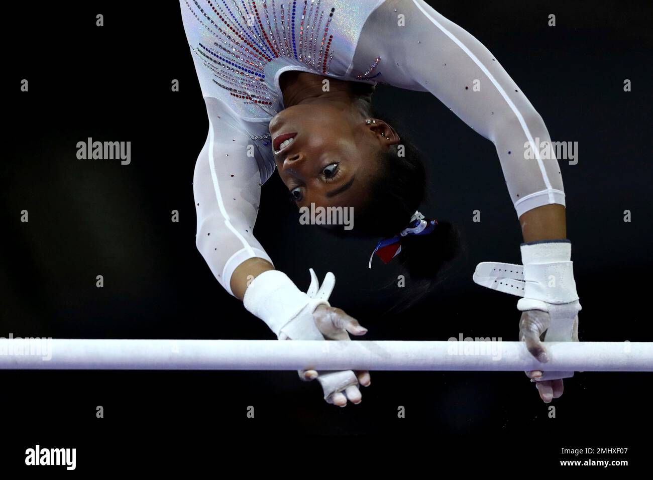 Simone Biles of the United States warms up on the uneven bars in the ...