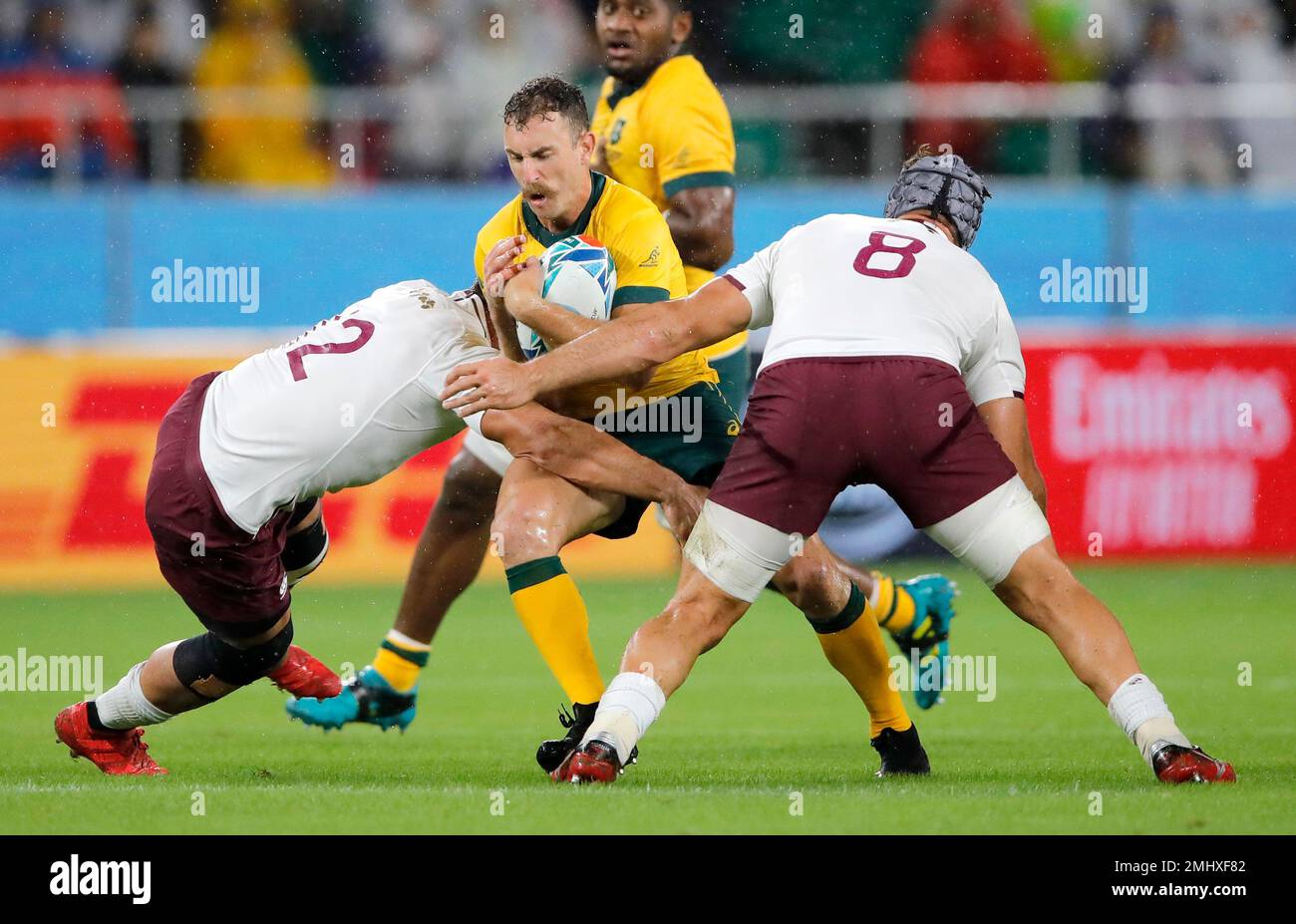 Australia's Nic White runs at Georgia's Merab Sharikadze, left, and ...
