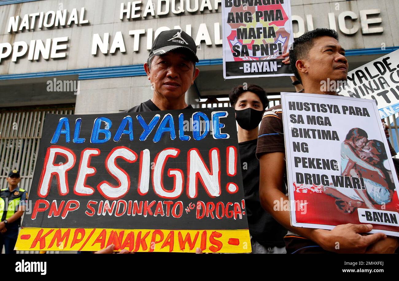 Protesters display placards during a brief rally at the Philippine ...