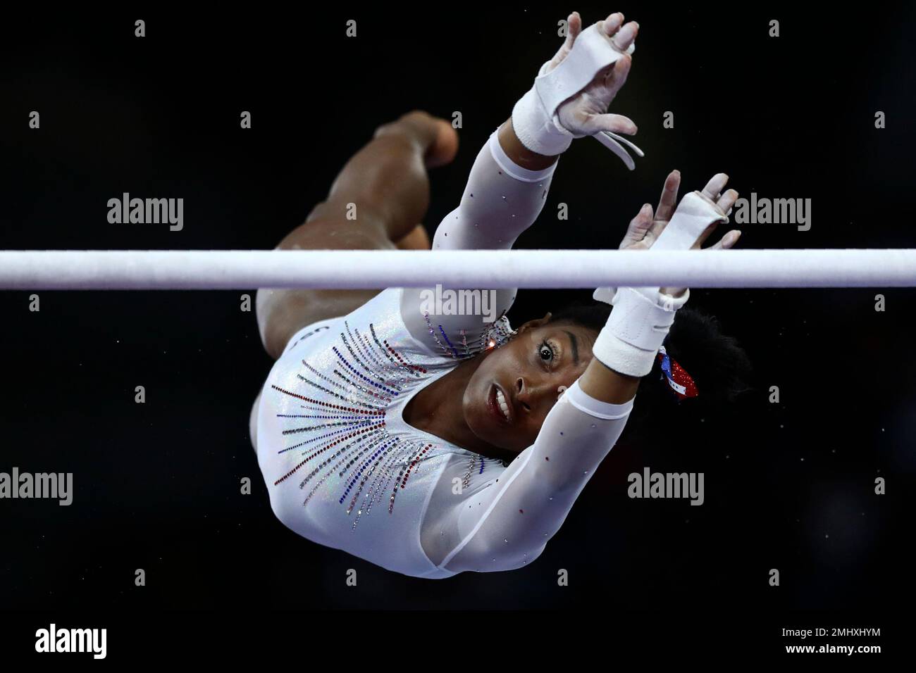 Simone Biles of the United States performs on the uneven bars during ...