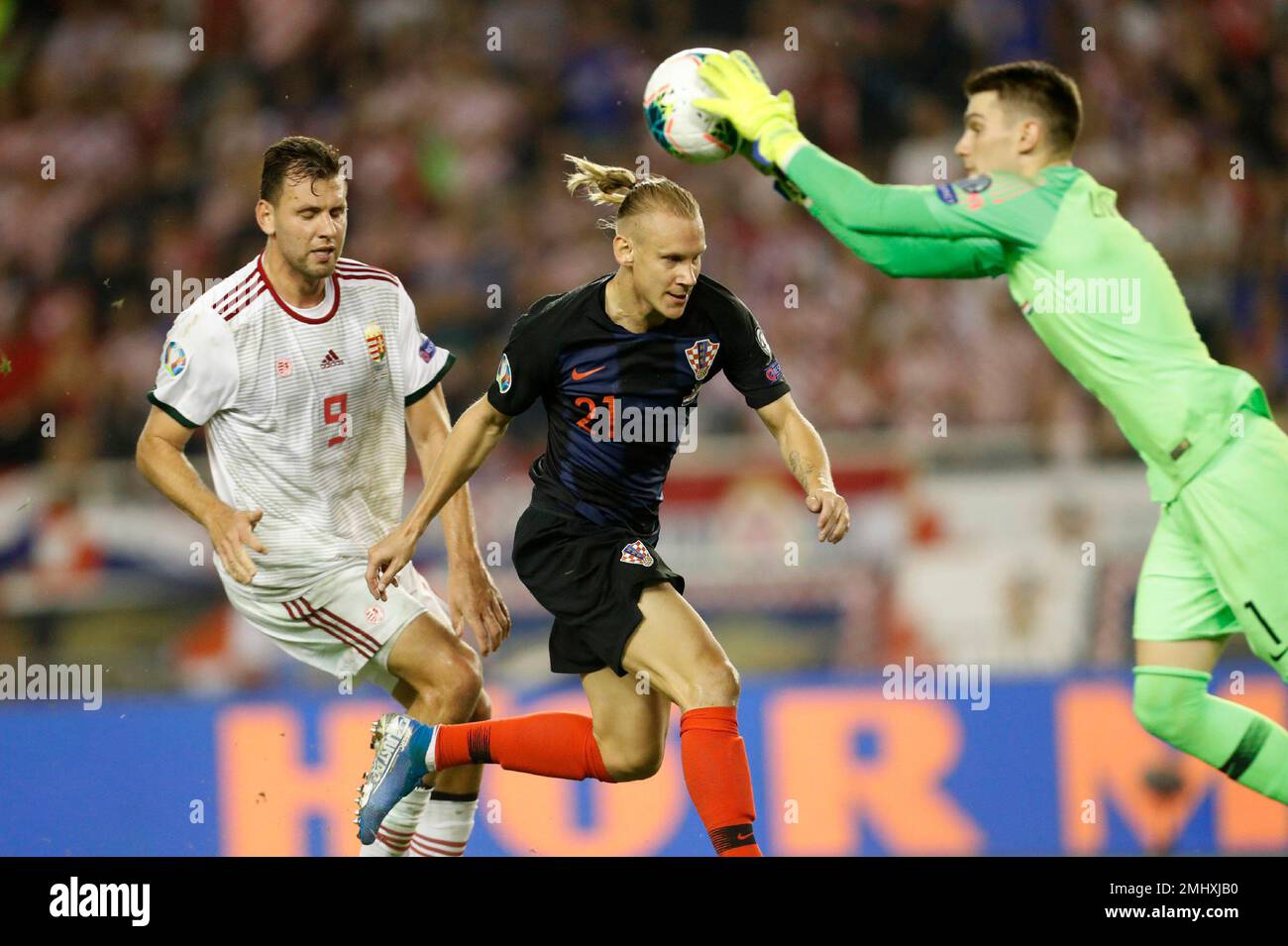 Croatia's goalkeeper Dominik Livakovic controls ball by his teammate ...