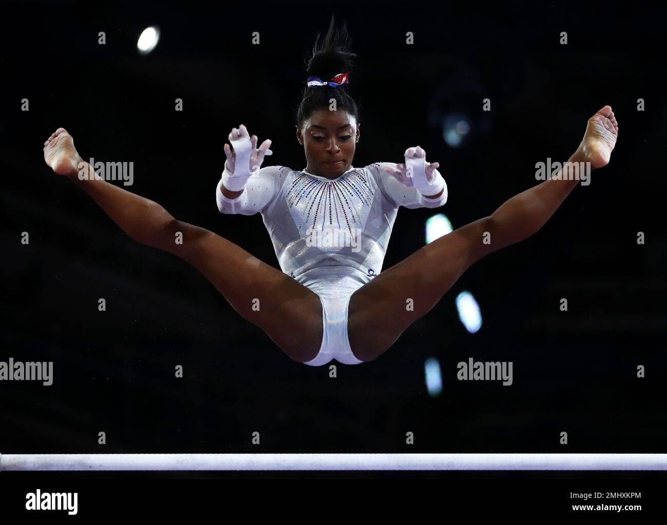 Simone Biles of the United States performs on the uneven bars in the ...