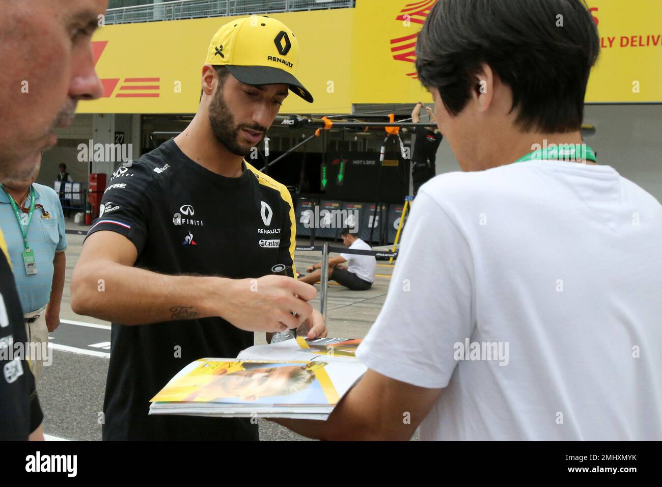 Renault driver Daniel Ricciardo of Australia signs his autograph after ...