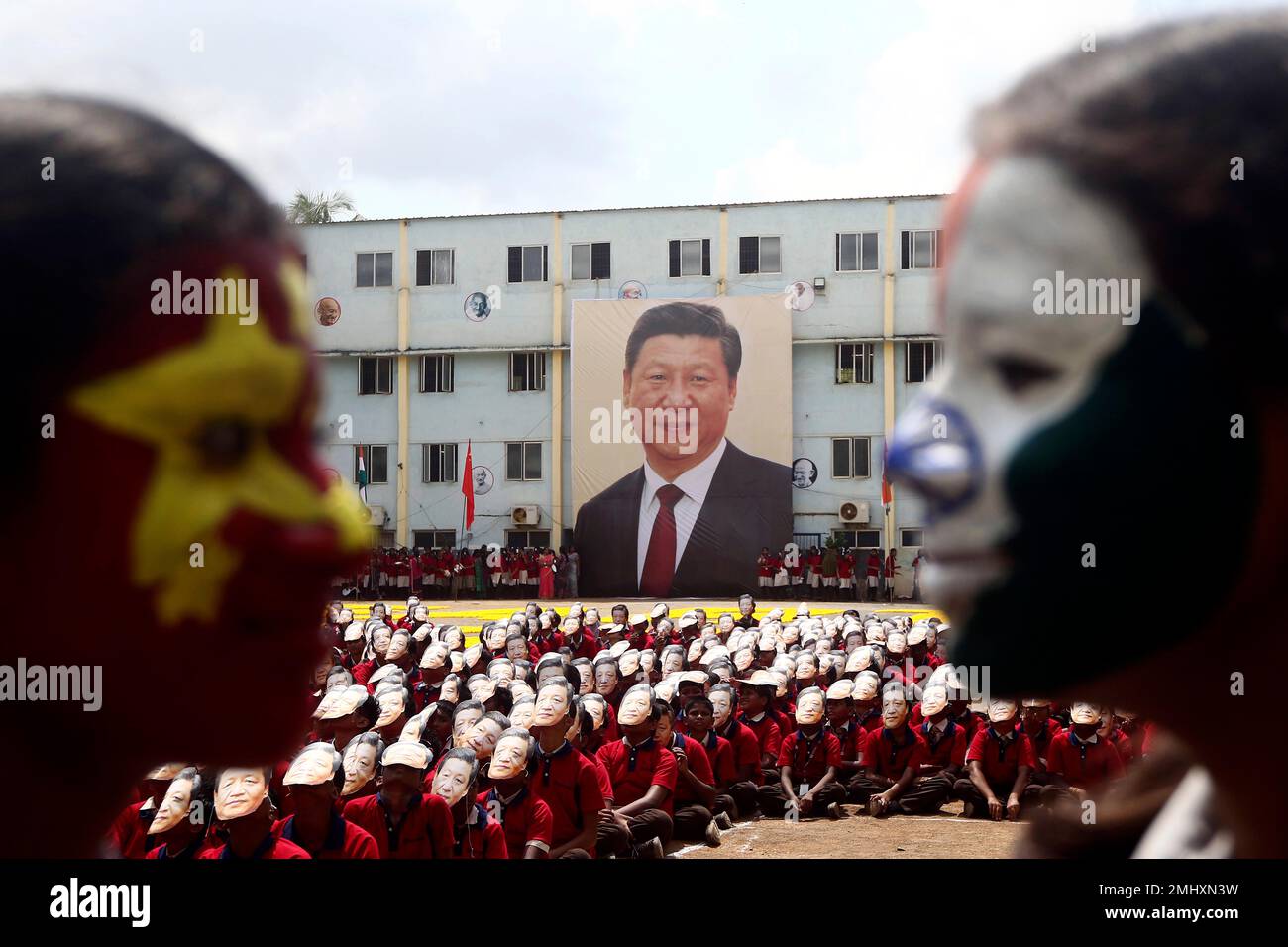 Indian school children wear face masks of Chinese President Xi Jinping ...