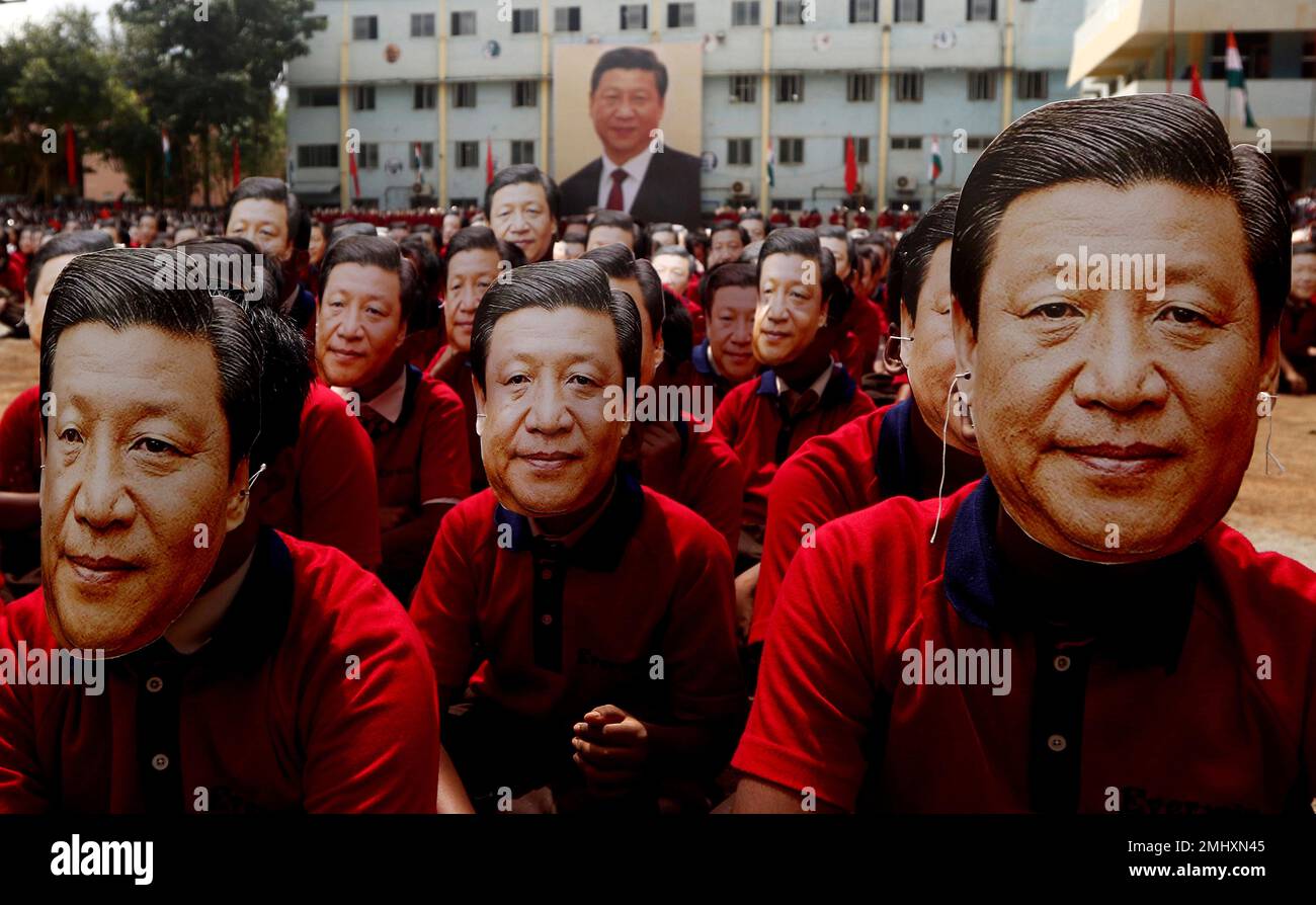 Indian school children wear face masks of Chinese President Xi Jinping ...