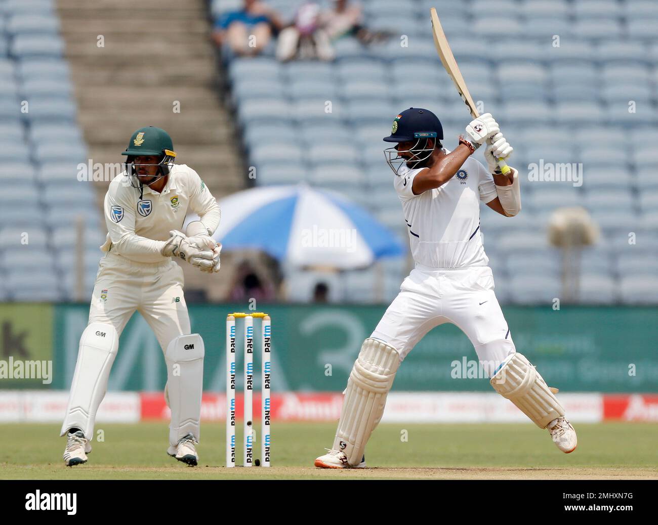 India's cricketer Cheteshwar Pujara, right, bats during the second ...