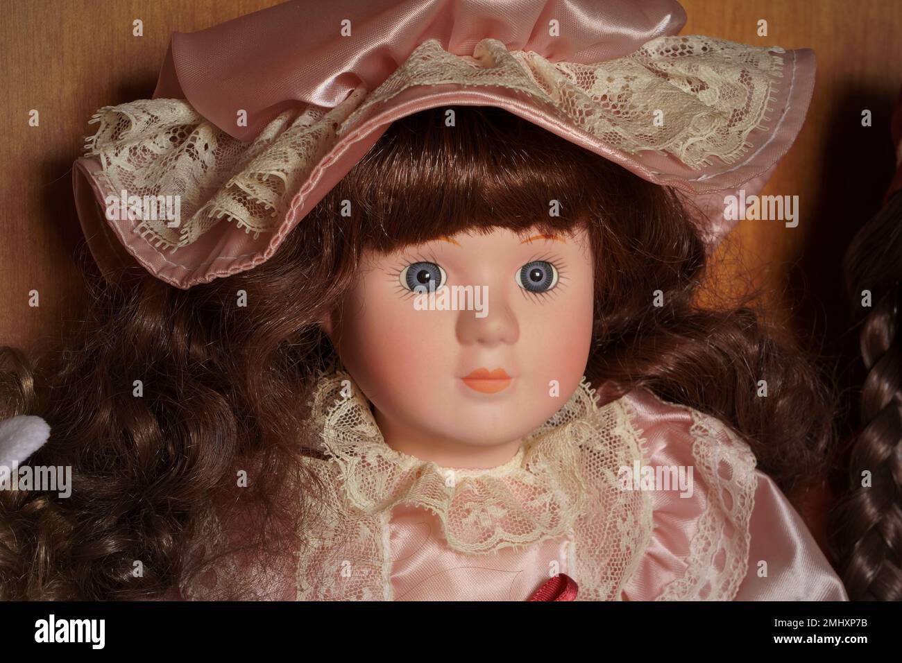 Doll with blue eyes and a pink suit Stock Photo - Alamy