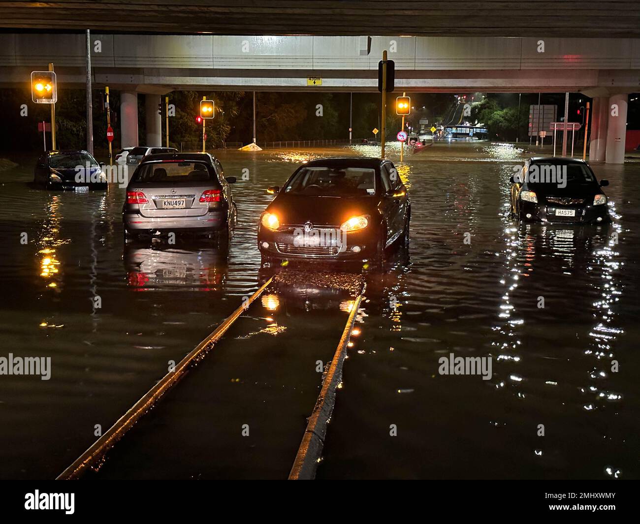 Aukland, New Zealand. 27th Jan, 2023. Vehicles drive on a flooded ...
