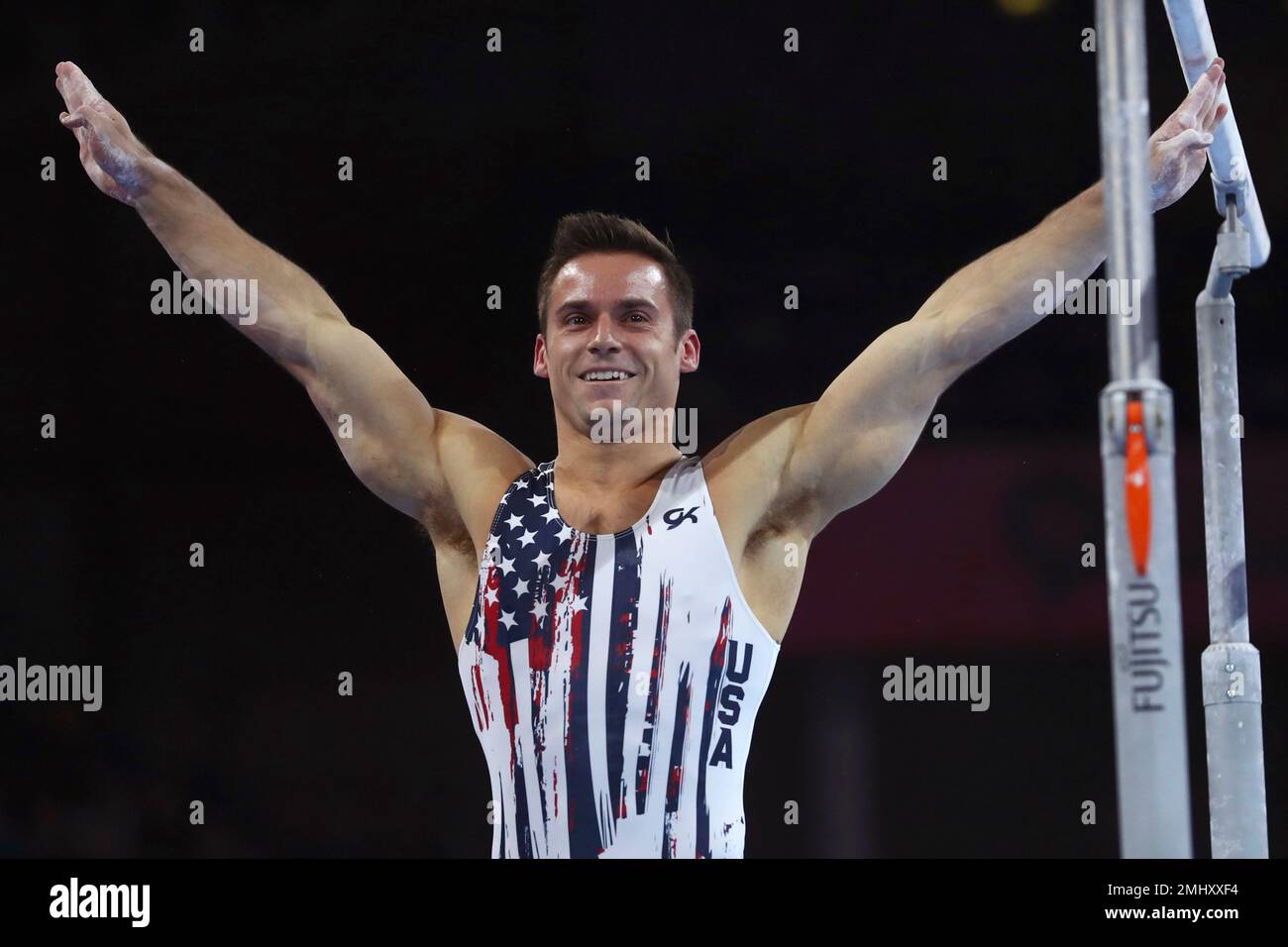 Samuel Mikulak of the United States performs on the parallel bars in ...