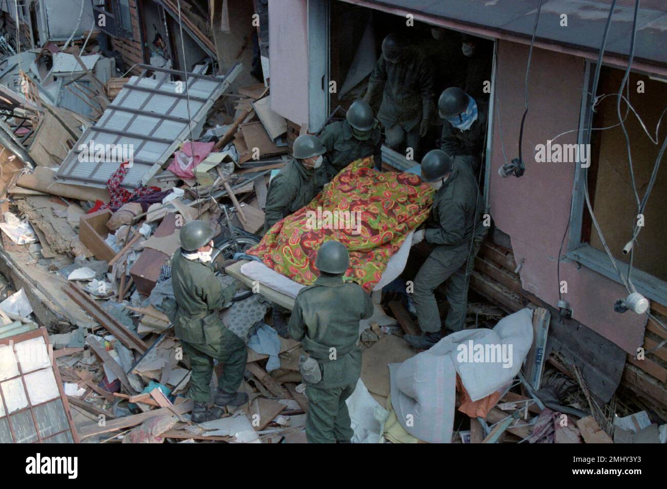 Japan Self Defense troops remove an earthquake victim from a home in ...