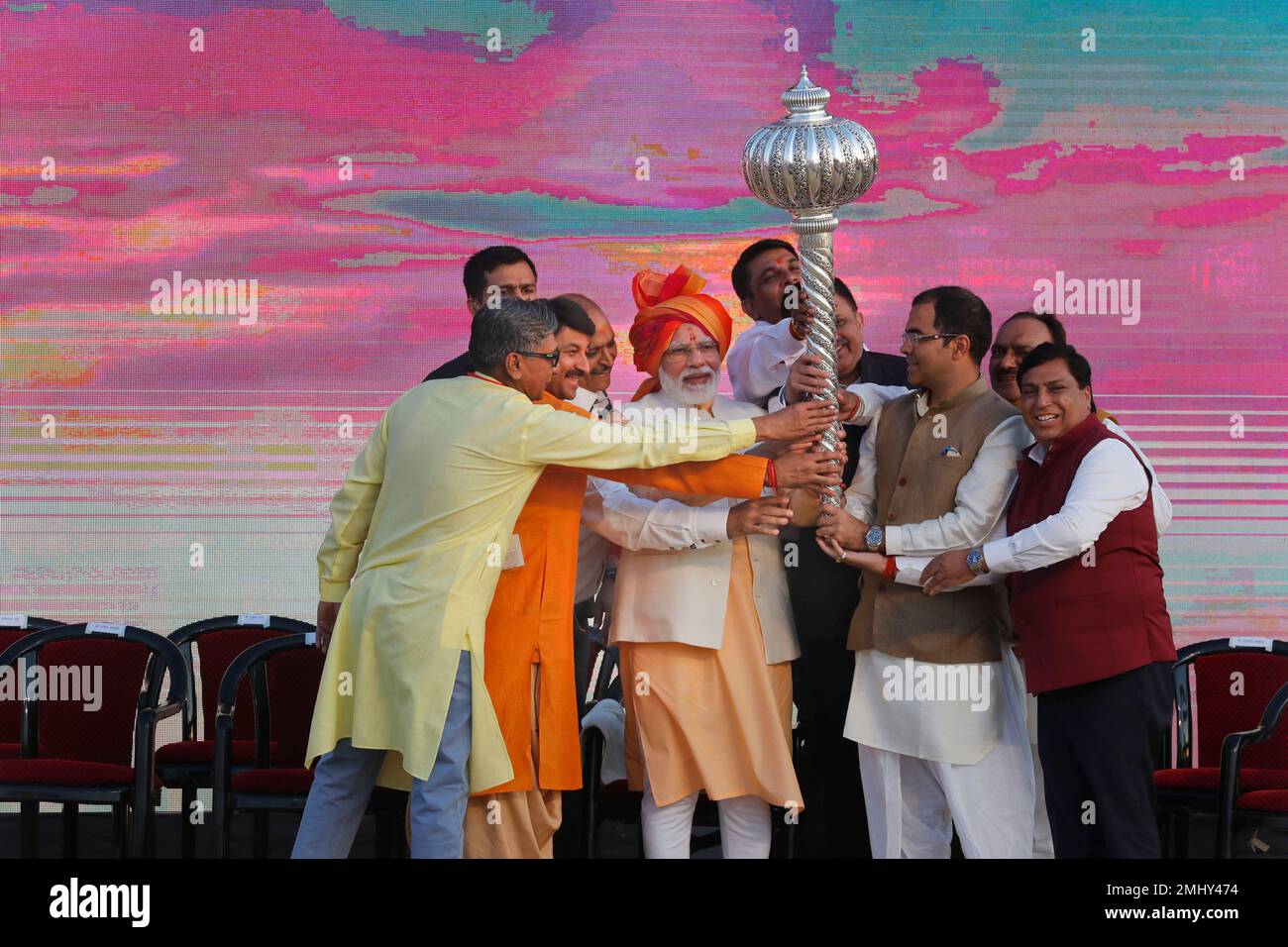 Indian Prime Minister Narendra Modi, wearing turban, is presented with ...