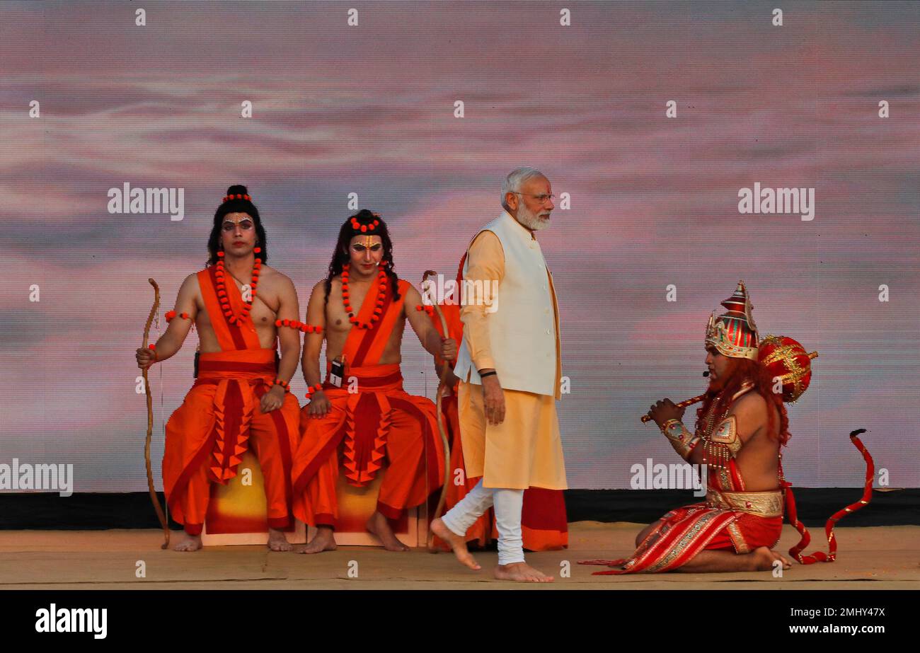 Indian Prime Minister Narendra Modi walks past artists dressed as Hindu ...