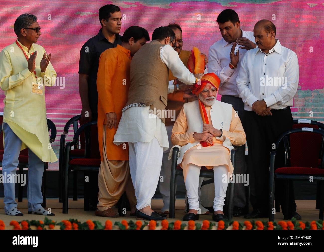 Indian Prime Minister Narendra Modi is presented with a turban as he ...