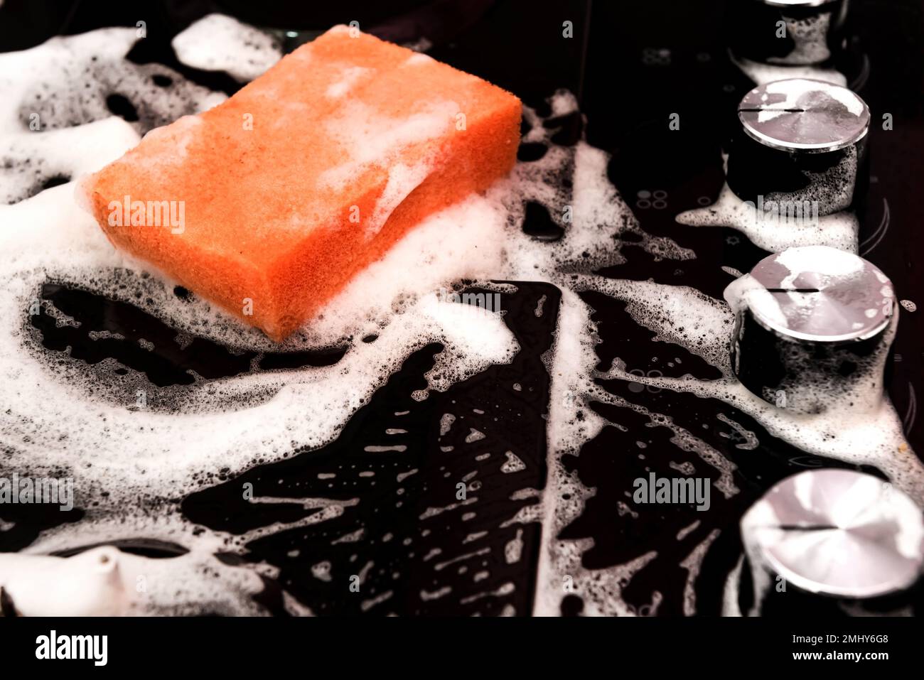 Cleaning a gas stove with kitchen utensils, household concepts, or ...