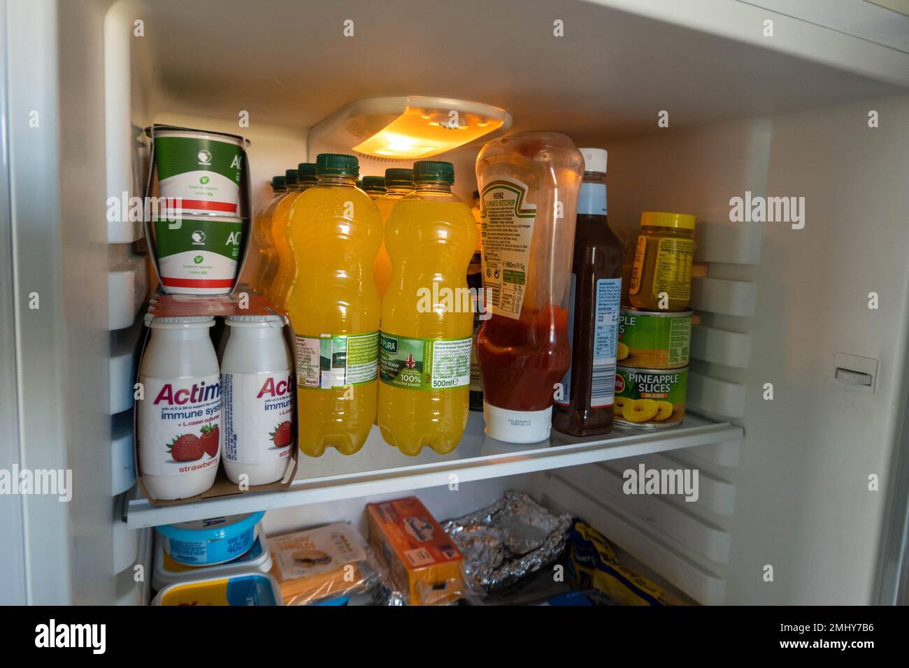 Inside view of a fridge with various food and drinks on view Stock ...