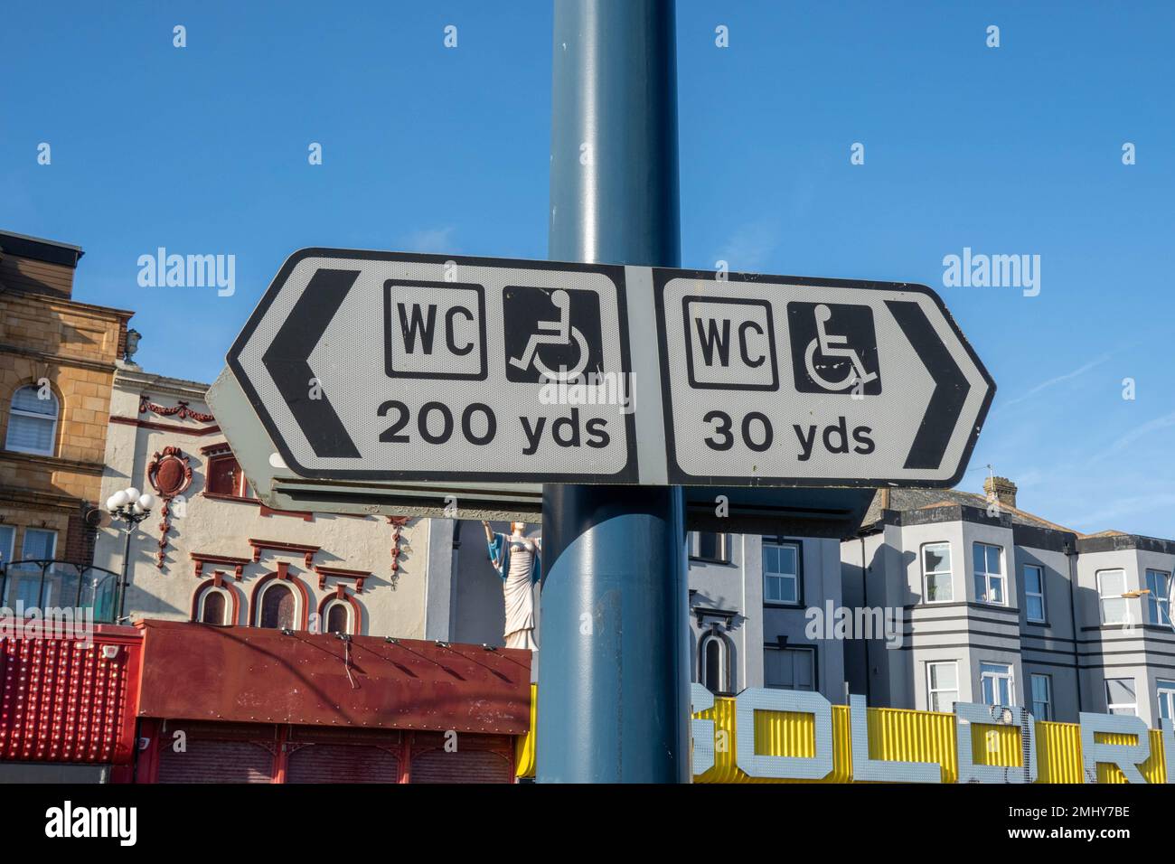 Great Yarmouth seafront. WC signs pointing in either direction with ...