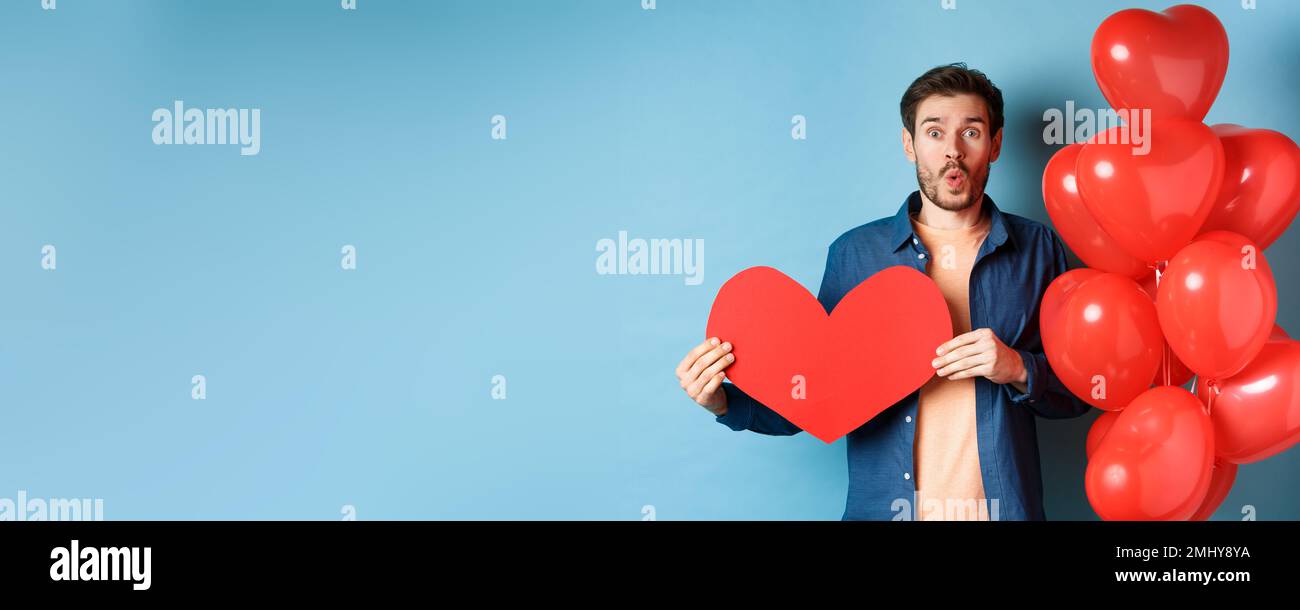 Valentines day concept. Boyfriend in love looking amazed at camera ...