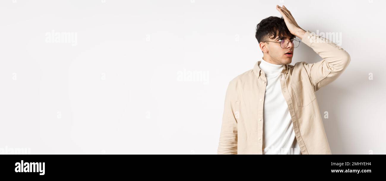 Portrait of annoyed stylish guy facepalm, roll eyes from something ...