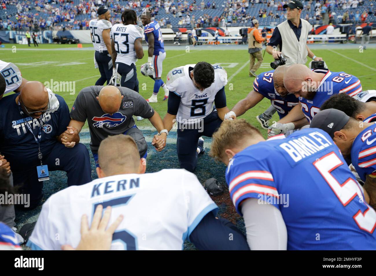 Players pray together after an NFL football game between the Tennessee ...