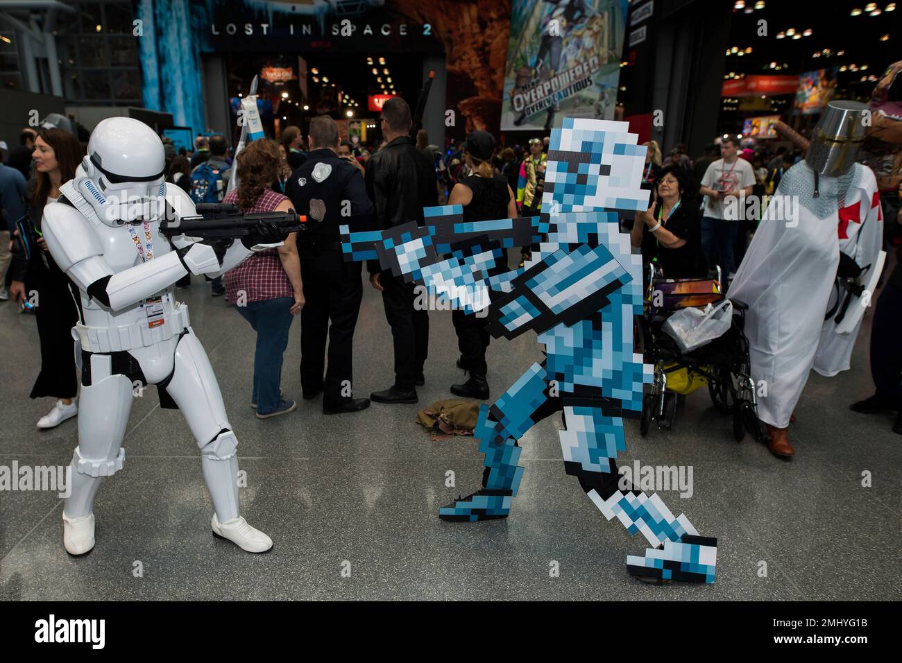 Attendees dressed as a Star Wars stormtrooper and pixelated video game ...