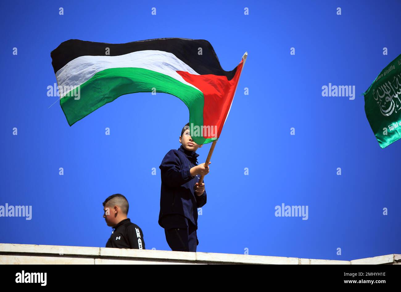 Al Ram, Palestine. 27th Jan, 2023. A man waves a Palestinian flag ...