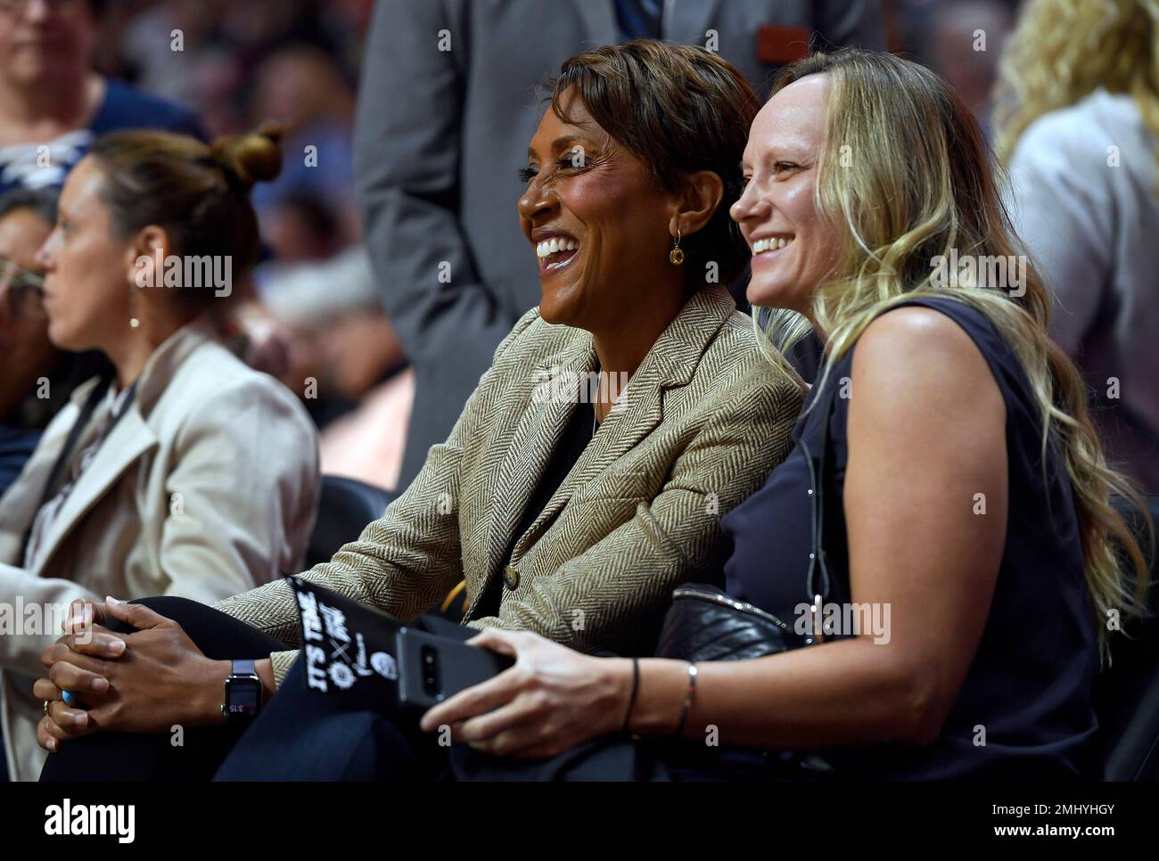 Broadcaster Robin Roberts, center, sits with partner Amber Laign, right ...
