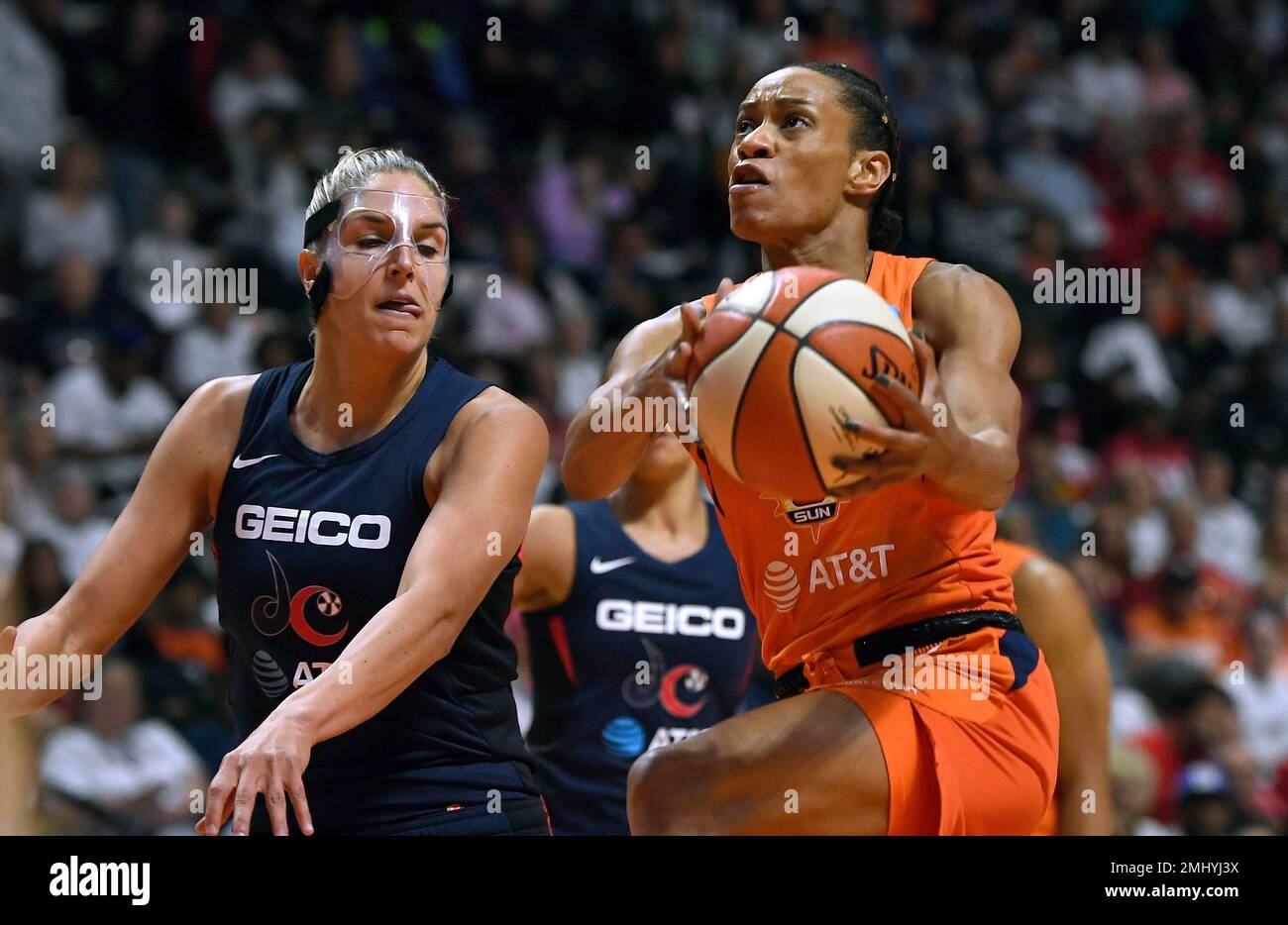 Connecticut Sun's Jasmine Thomas, right, drives against Washington ...