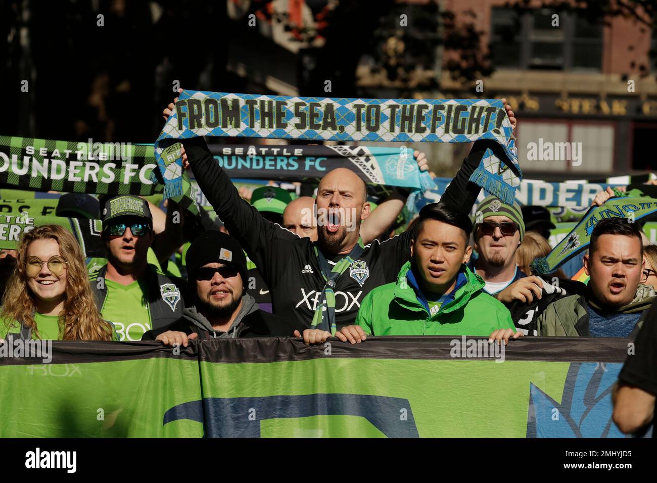 Seattle Sounders supporters hold up scarves as they take part in the ...