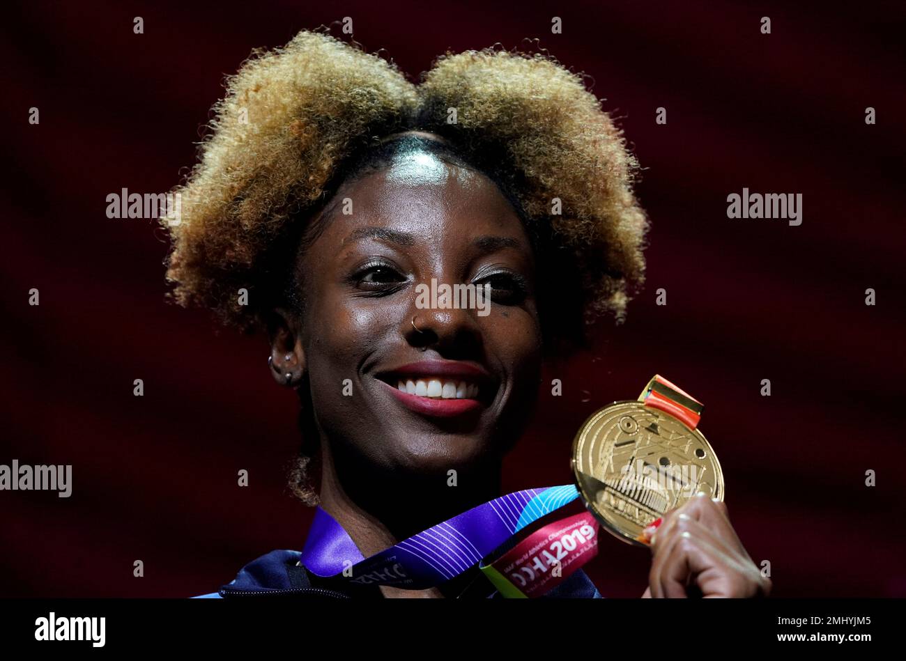 Gold medalist Nia Ali, of the United States poses with her medal for ...