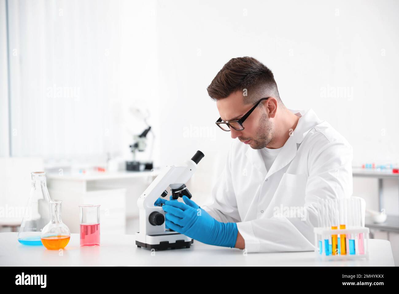Scientist using modern microscope at table. Medical research Stock ...