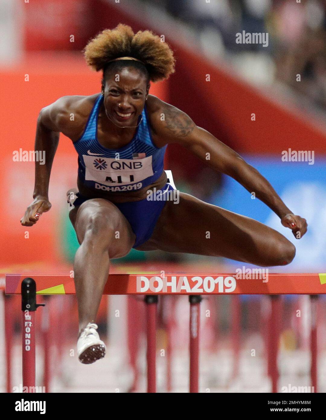 Nia Ali, of the United States races to win the gold medal in the women ...