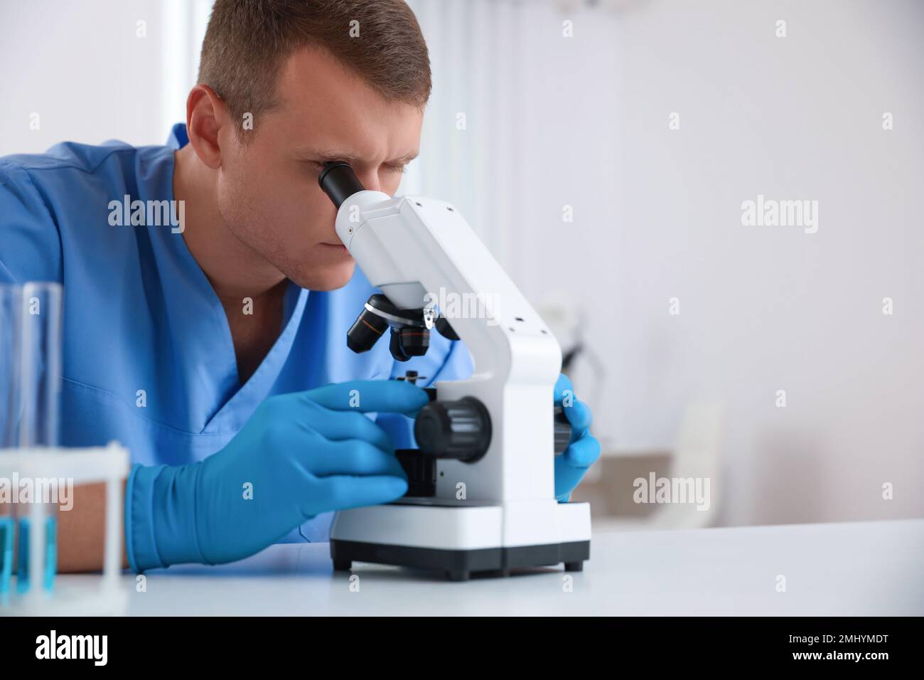 Scientist using modern microscope at table, closeup. Medical research ...