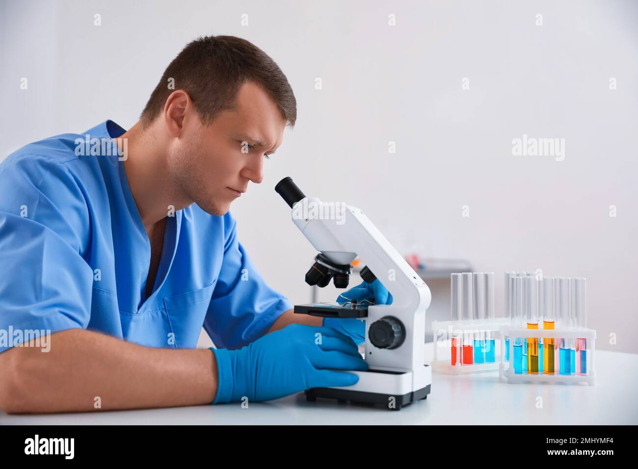 Scientist using modern microscope at table. Medical research Stock ...