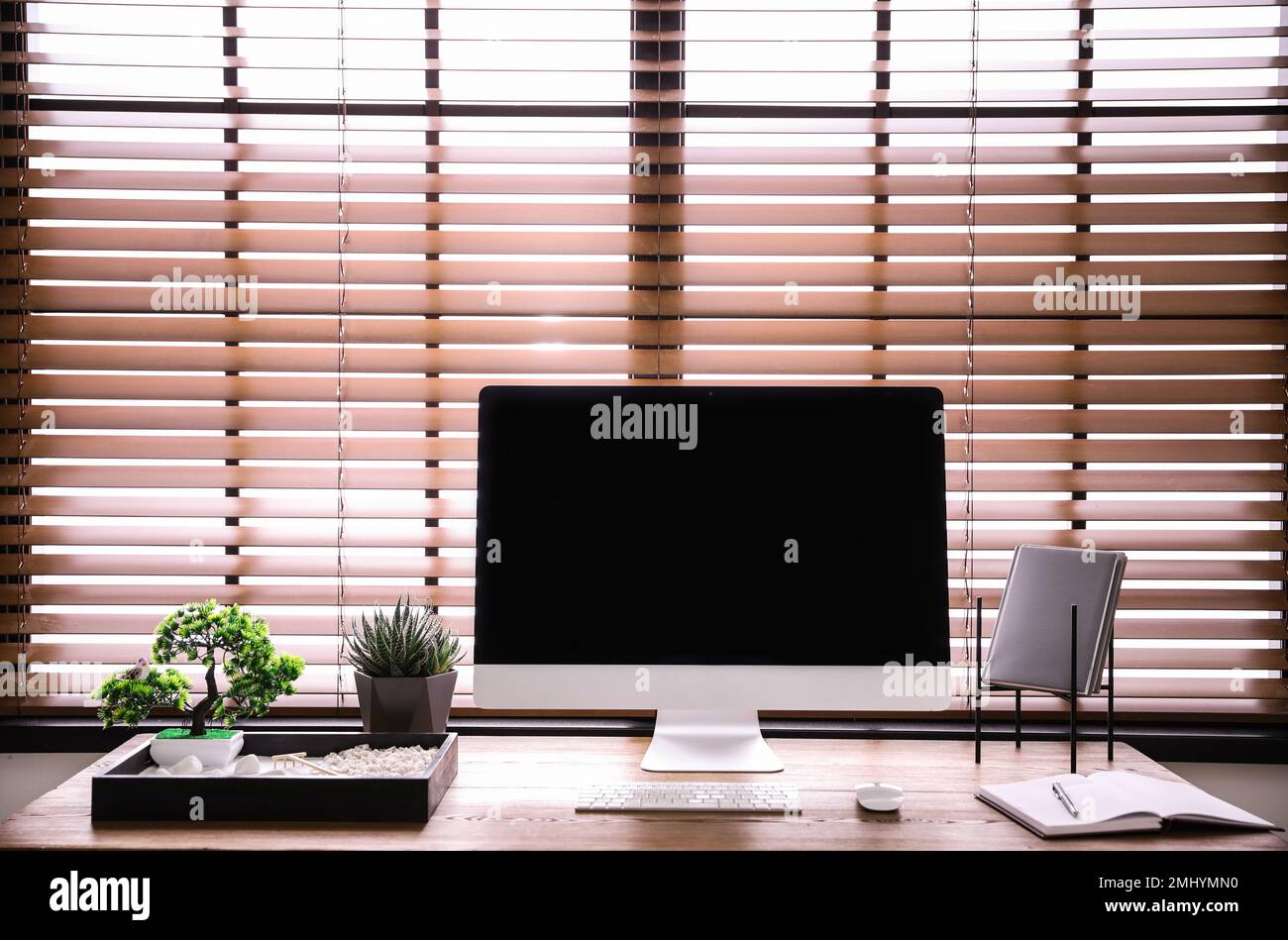 Modern workplace with beautiful miniature zen garden and computer in ...