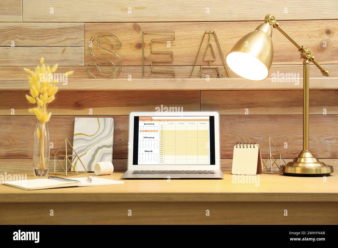 Modern laptop with calendar on screen in office Stock Photo - Alamy