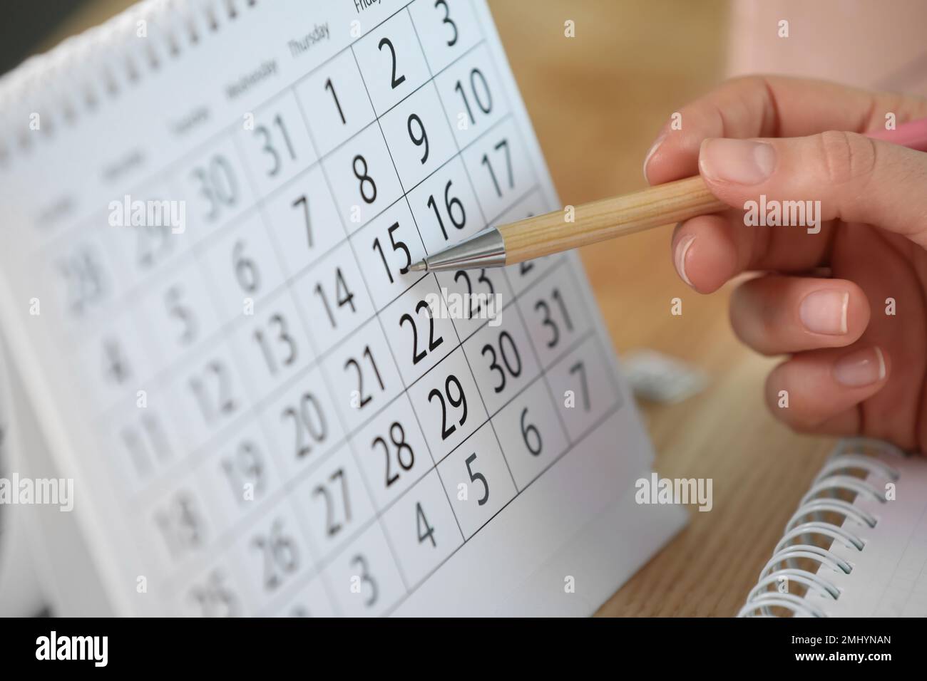 Woman making schedule using calendar at wooden table, closeup Stock ...