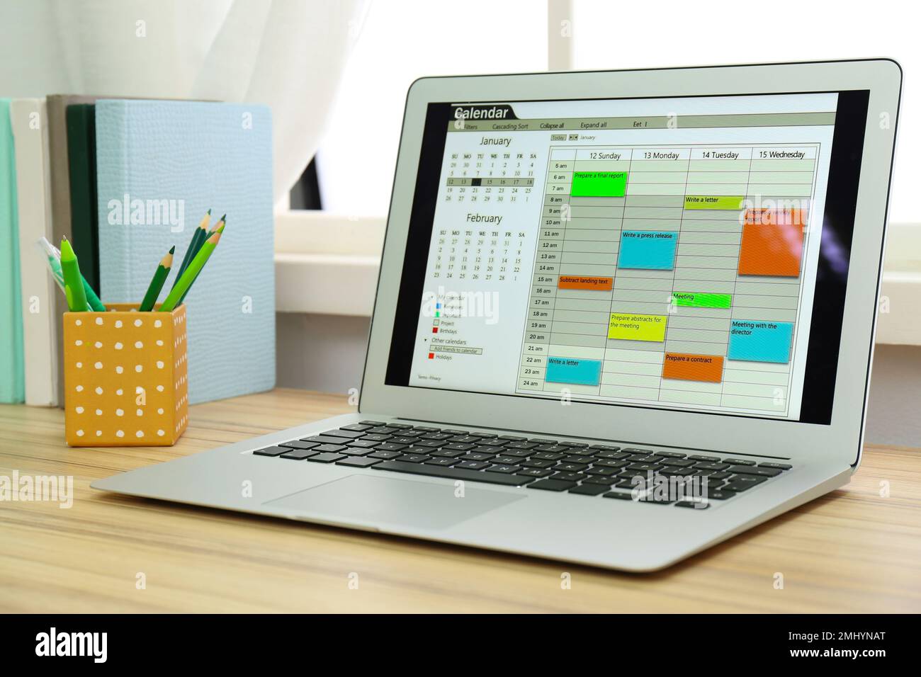 Modern laptop with calendar on screen in office Stock Photo - Alamy
